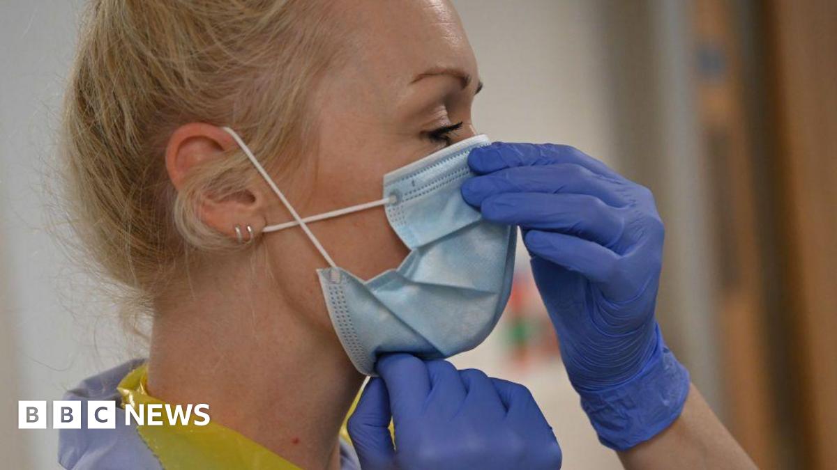 People asked to wear face masks in hospitals as flu cases rise - BBC News