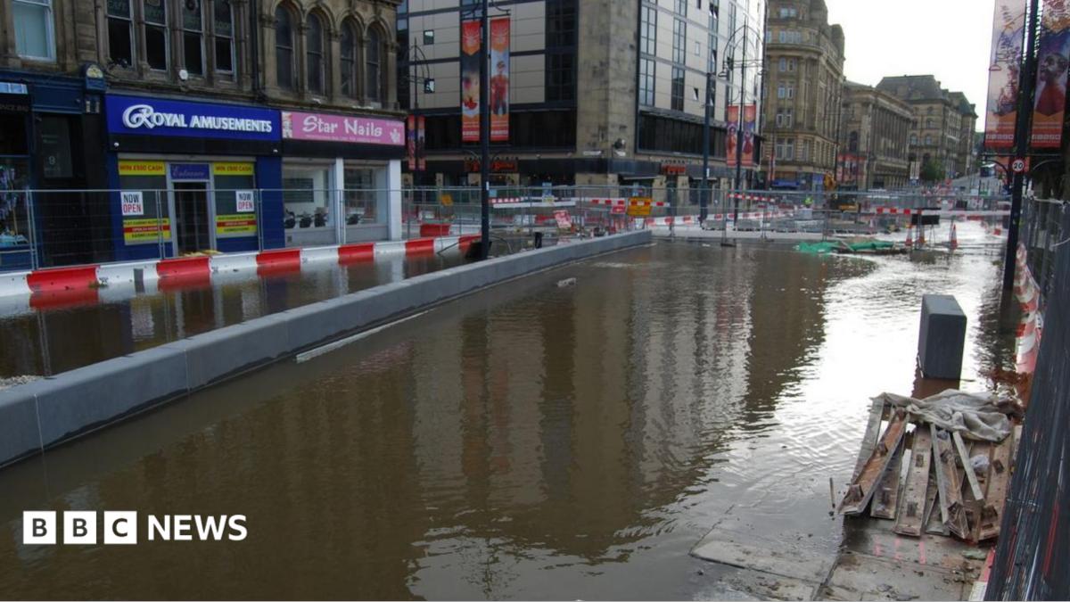 Investigation after burst main floods street - BBC News