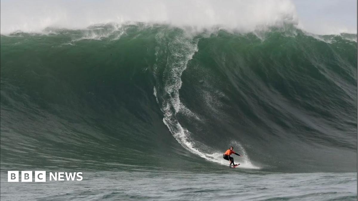 Surfers take on giant waves as storm hits California - BBC News