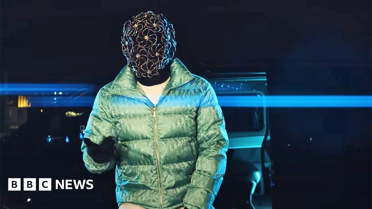 Dide: Who is the masked Premier League rapper? - BBC News