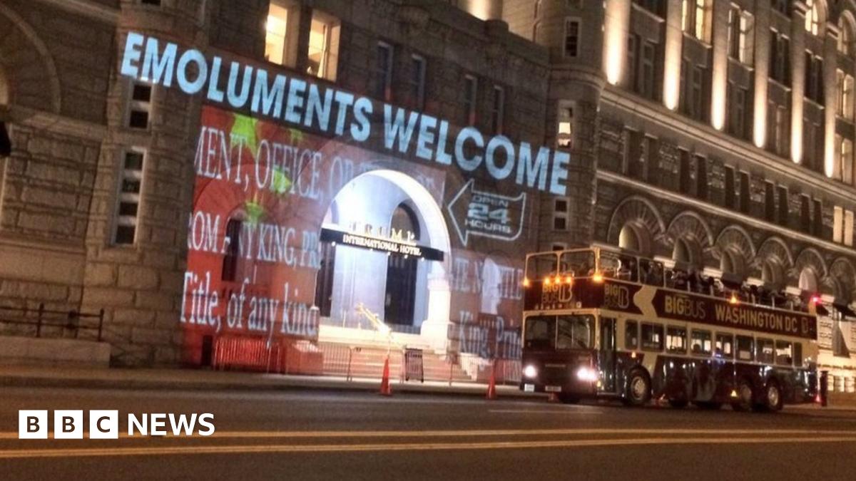 Protest message projected on Trump hotel in Washington DC - BBC News