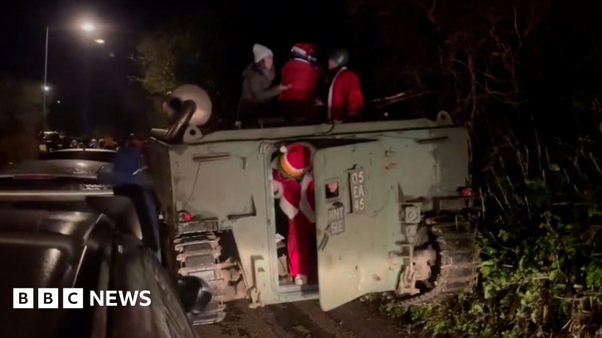 Santa-filled armoured truck gets stuck in Cornwall lane - BBC News