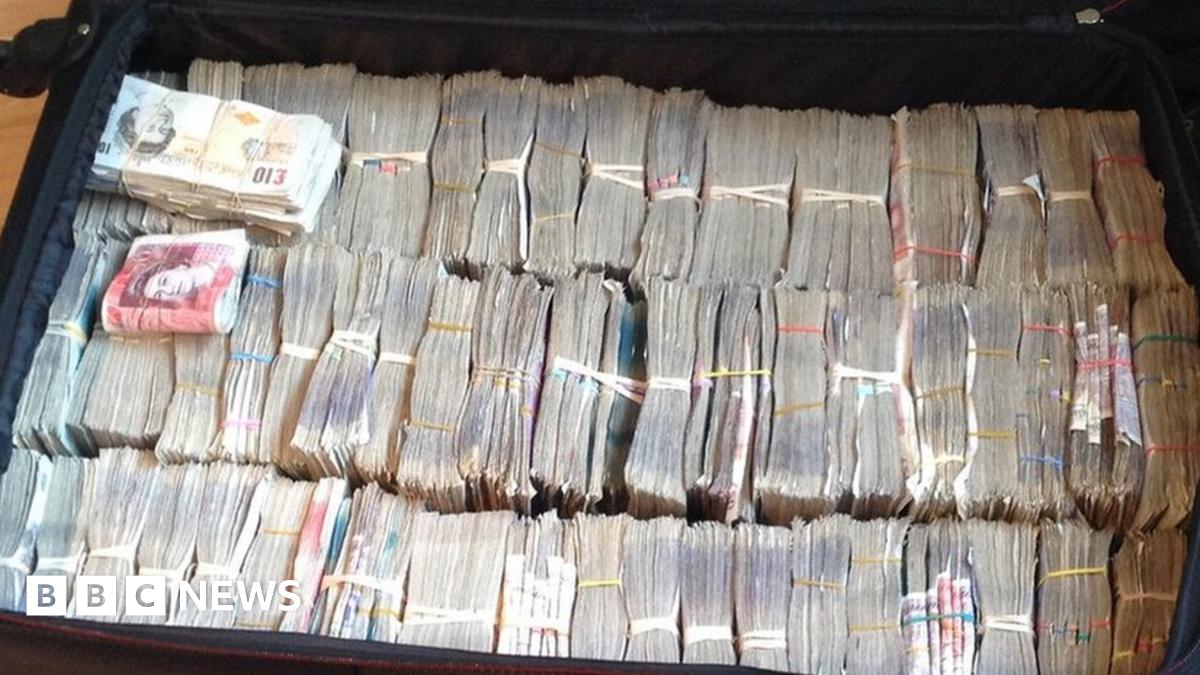 £530,000 cash and 12kg drugs found in Merseyside raids - BBC News