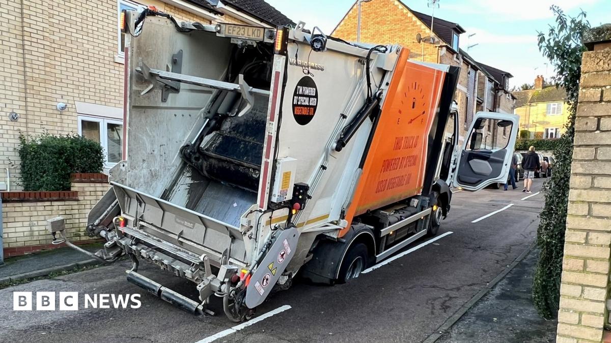 Bin lorry stuck in Stowmarket after road collapses underneath - BBC News