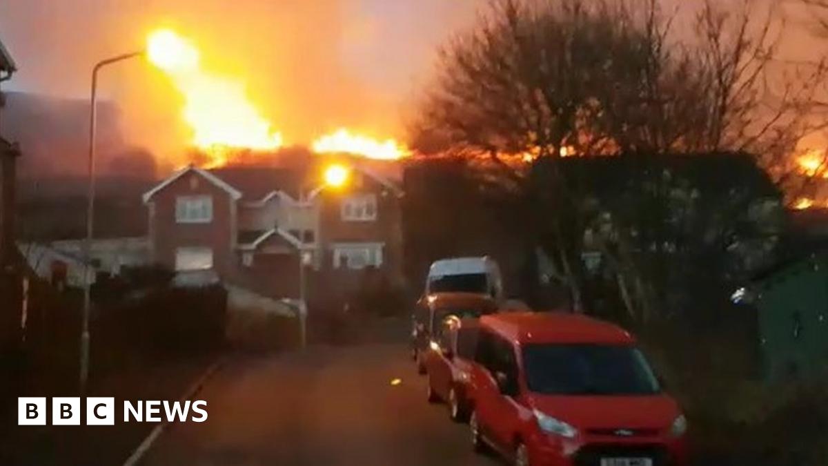 Fire crews tackle grass blaze on Penrhys mountain - BBC News