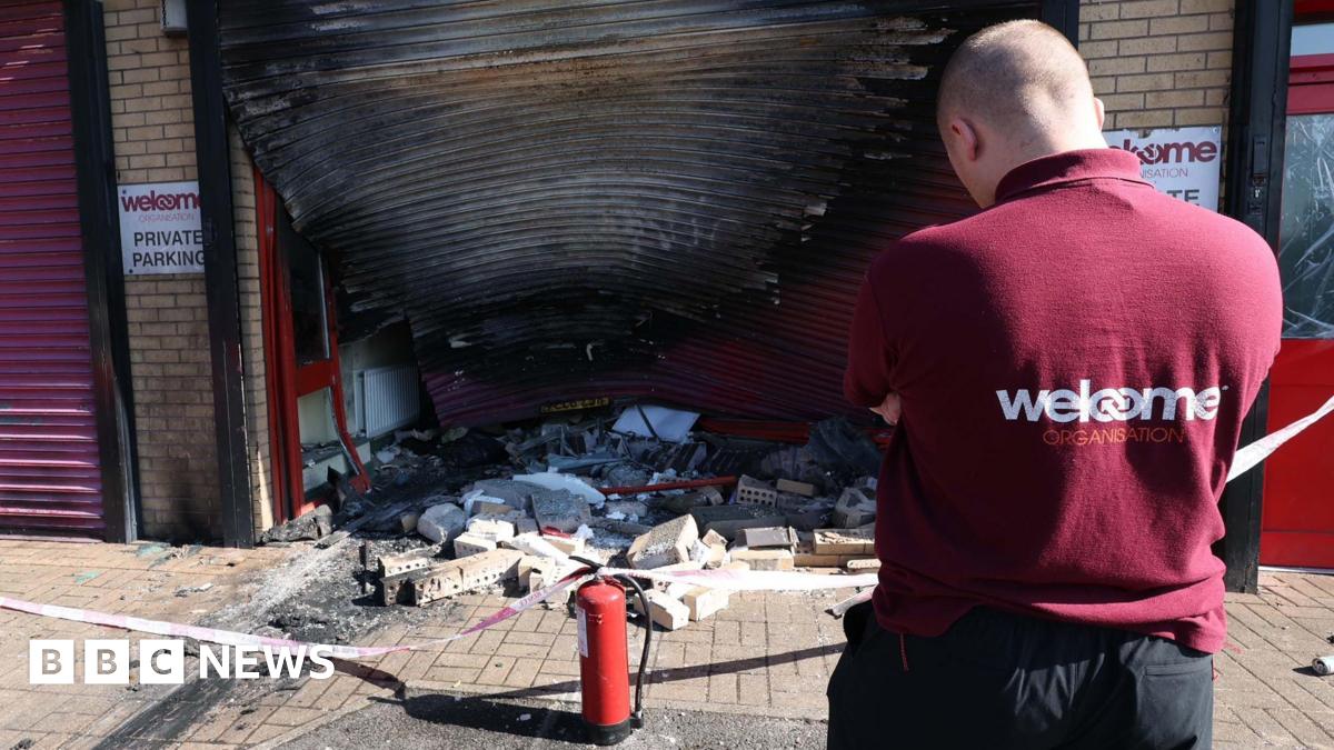 Car set alight after ramming Welcome Organisation hub - BBC News