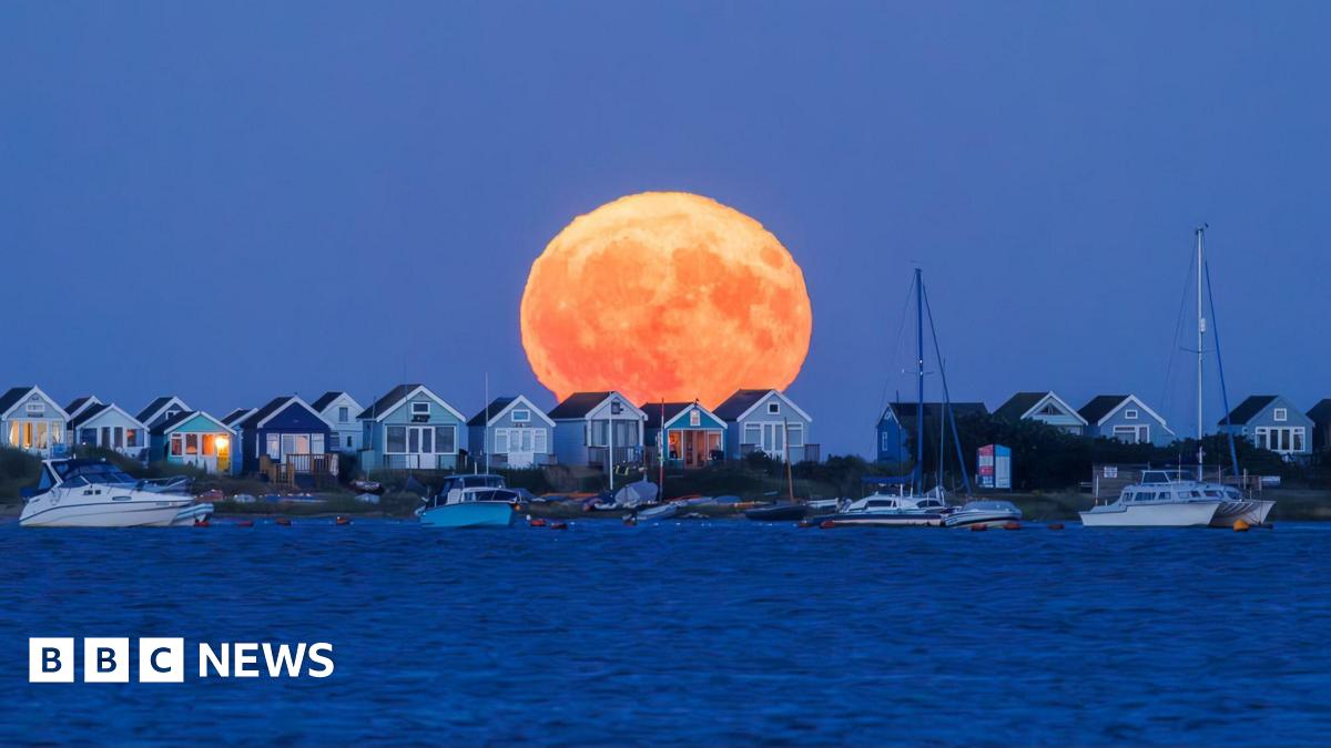 Orange Buck Moon captured across the south of England - BBC News