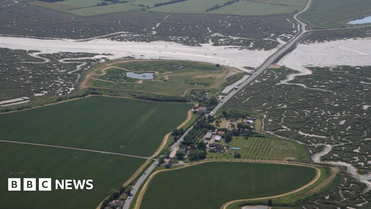 Driver rescued from Mersea Island causeway high tide - BBC News