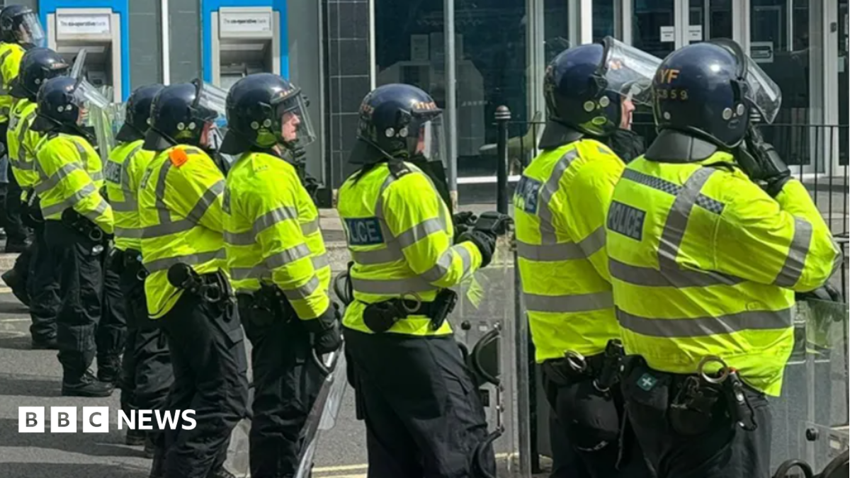 Staffordshire Police officer sprayed with petrol during riots - BBC News