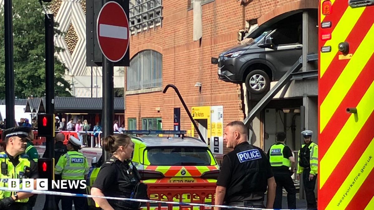 Vehicle crashes through first storey of Leeds NCP car park - BBC News