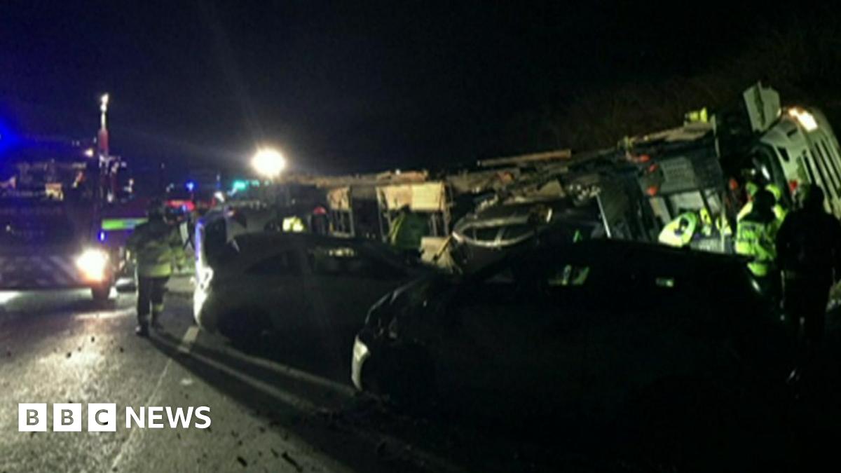 Twelve cars destroyed when transporter overturns in Devon - BBC News