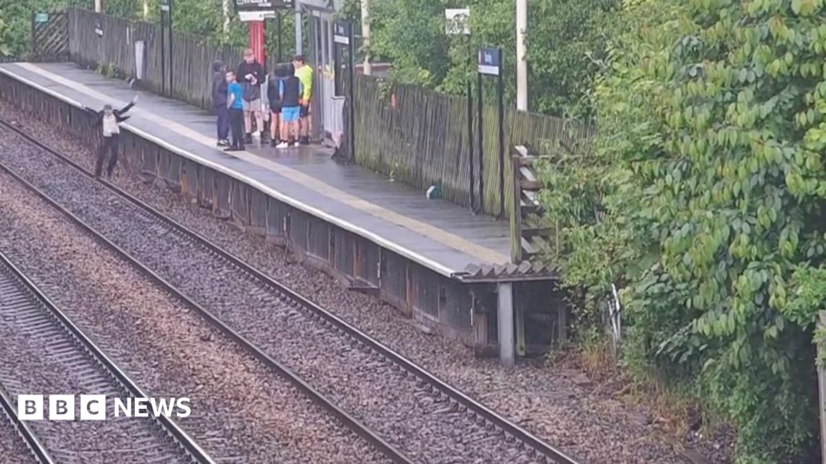 CCTV footage show moment boy jumps on railway tracks - BBC News