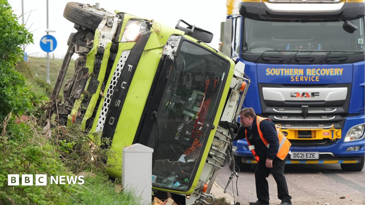 Bin lorry overturns in Saltdean after falling down steep bank - BBC News