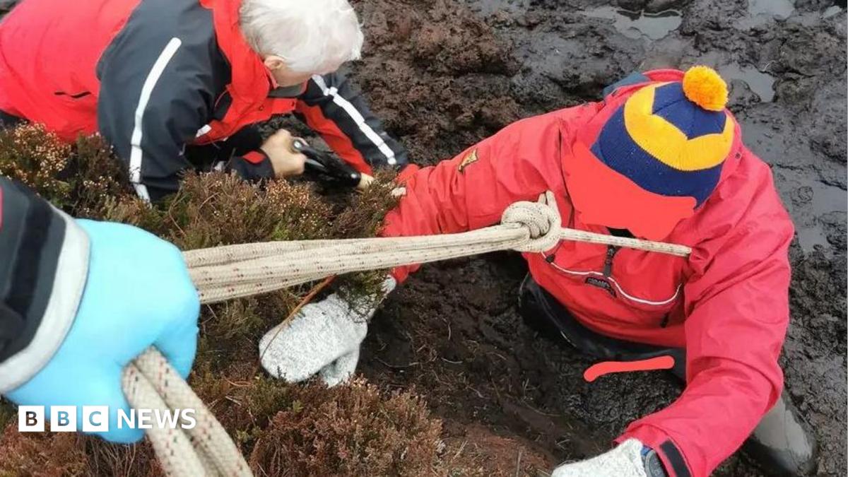 Walker stuck waist-deep in bog rescued from Burnslack Fell - BBC News