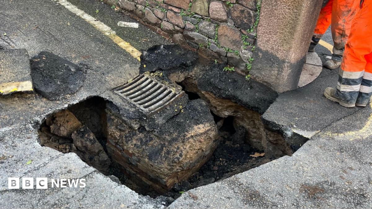 Jersey sinkhole under road causes unstable building closure - BBC News
