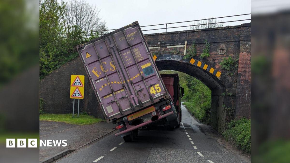 Lorry lodged under bridge as driver fined for careless driving - BBC News