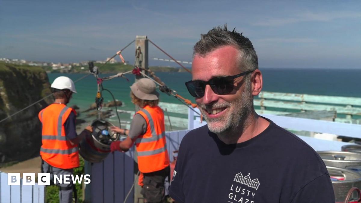 Cornwall beach bar turns to zip line for delivery of beer kegs - BBC News