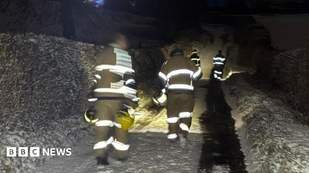 Firefighters trudge through snow to reach chimney fire - BBC News