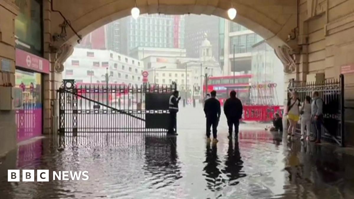 UK weather: Heavy rain floods London Tube stations and roads - BBC News