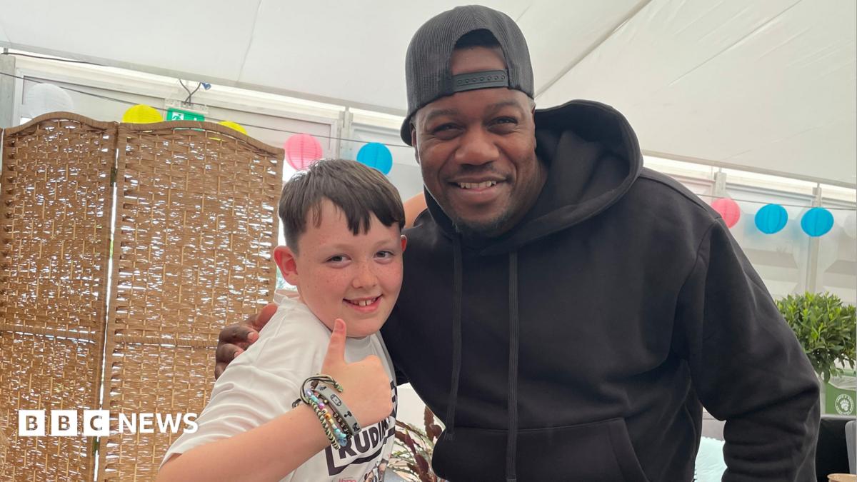 Rudimental's Locksmith meets 10-year-old carer at festival - BBC News