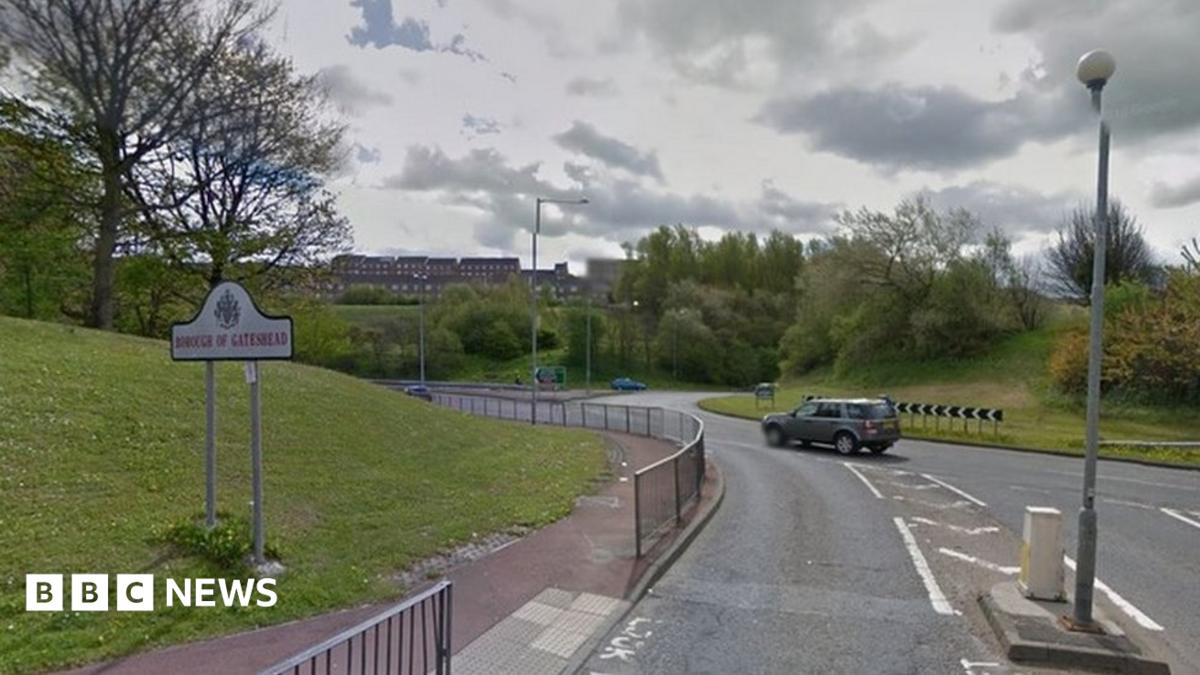 One dead as crash leaves car on roof on Gateshead roundabout - BBC News