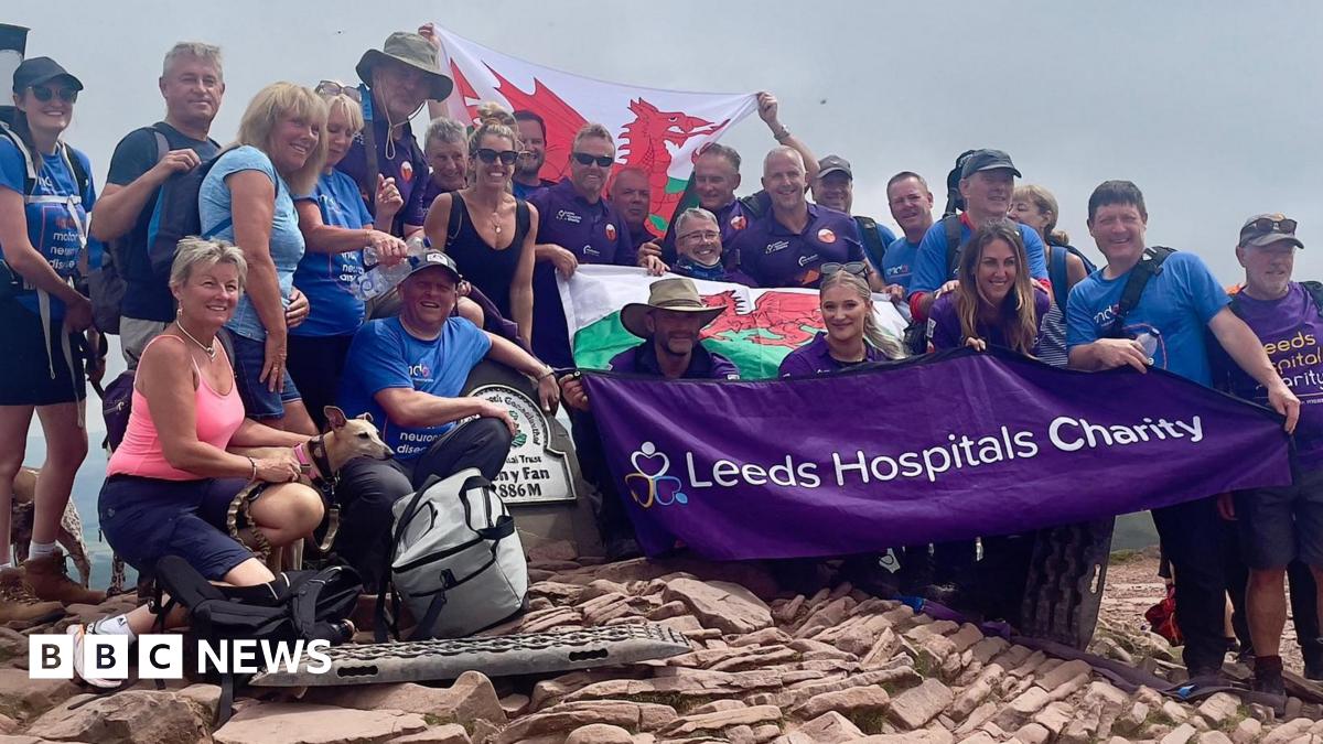 Rob Burrow: Man with MND scales Pen y Fan in wheelchair - BBC News
