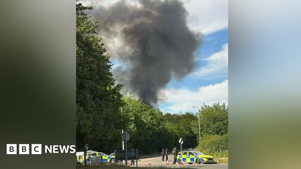 Bypass closed off as crews battle caravan park fire - BBC News