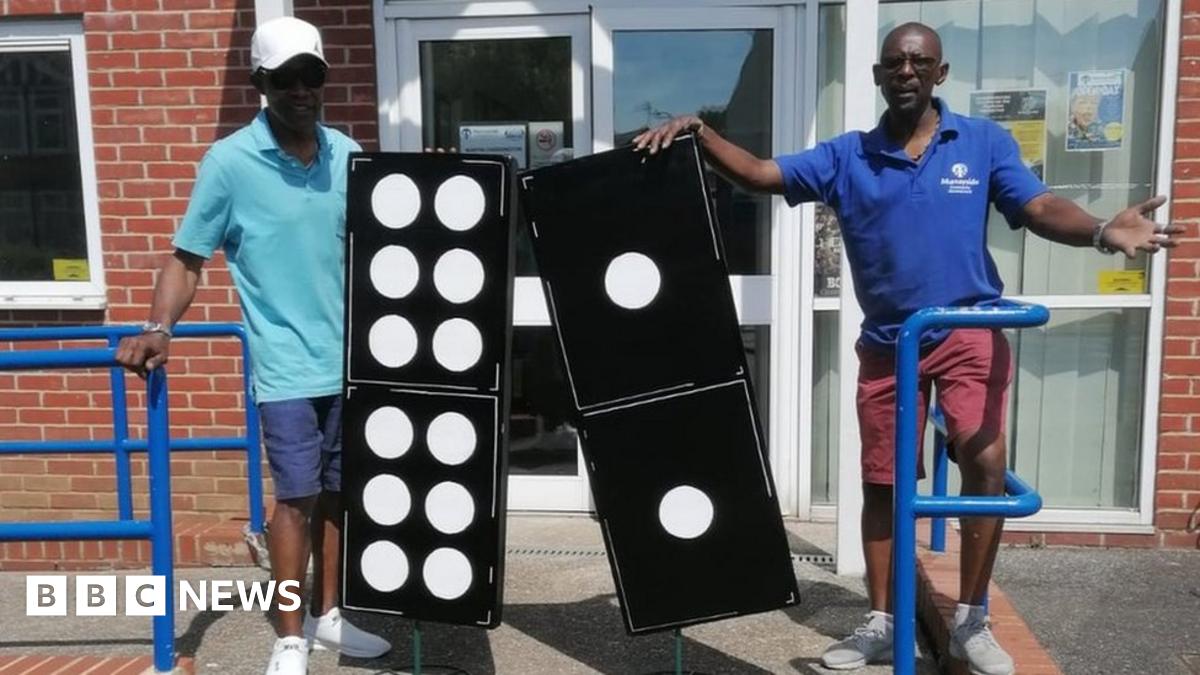 Dominoes tournament brings communities together for Windrush Day - BBC News
