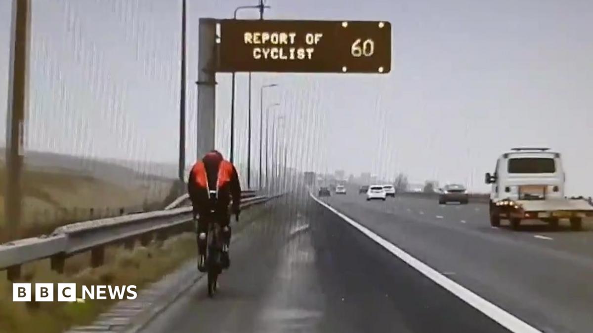 Cyclist on motorway filmed riding past bicycle warning sign - BBC News
