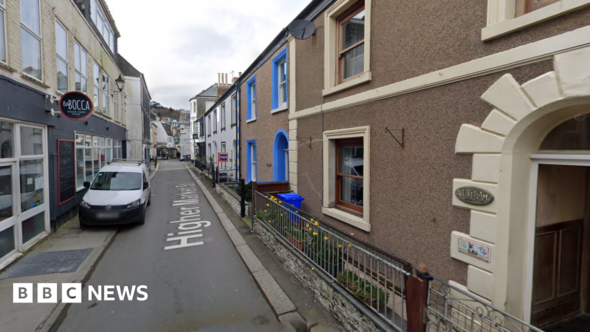 Crews fight bin fire that spread to building in East Looe - BBC News