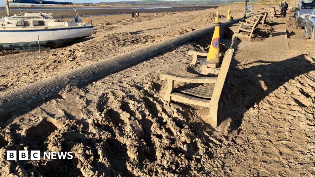 Sand bringing 'danger' and flooding to Instow road - BBC News
