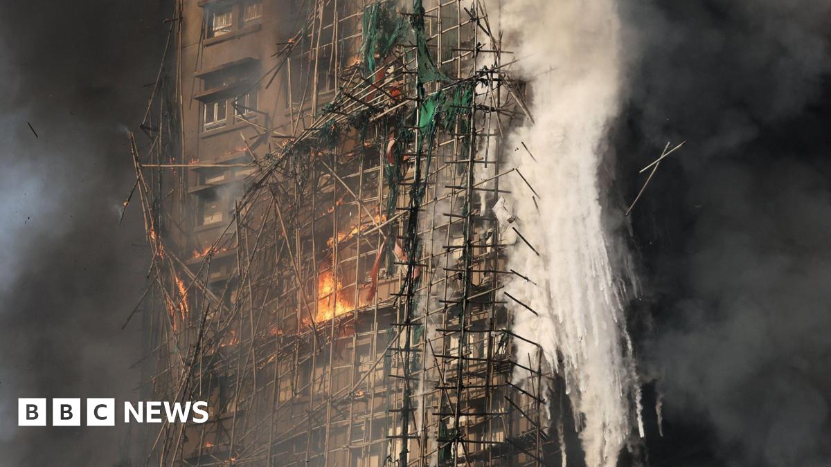 Hong Kong: Firefighters search for missing in tower blocks fire - BBC News