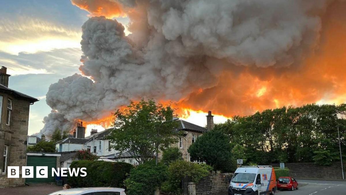 Huge plume of smoke as firefighters tackle industrial site blaze - BBC News