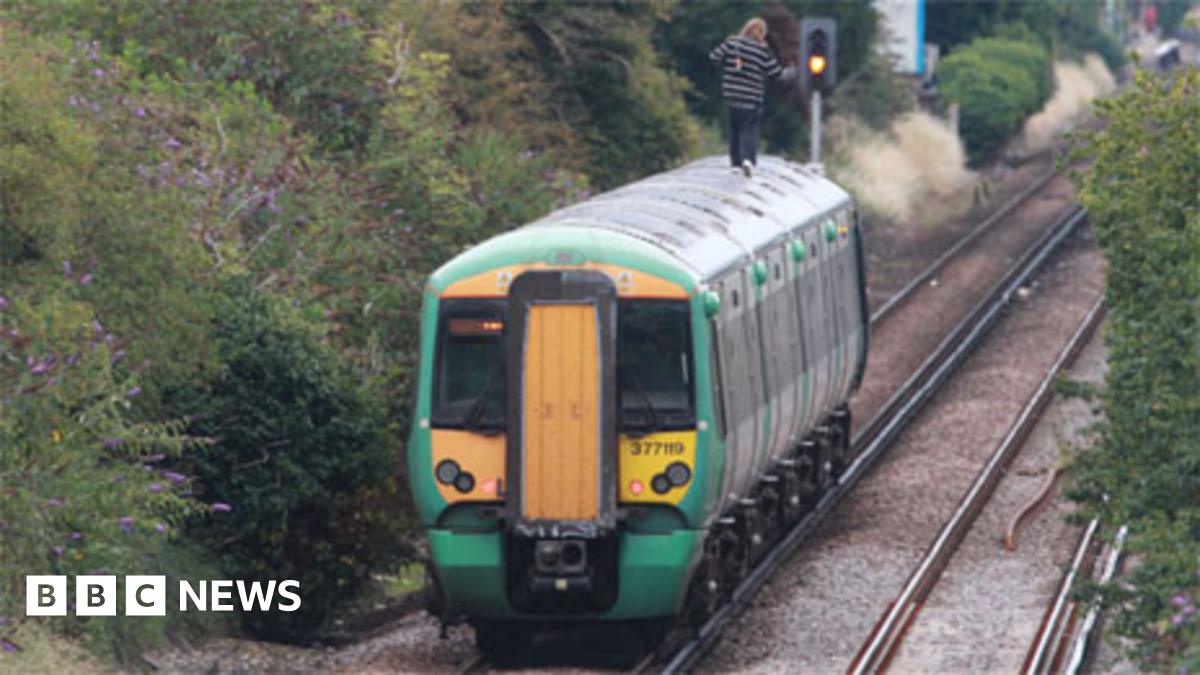 Sussex train delayed by man climbing on top of carriage - BBC News