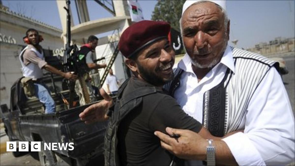 Libyans celebrate their freedom as they mourn the dead - BBC News