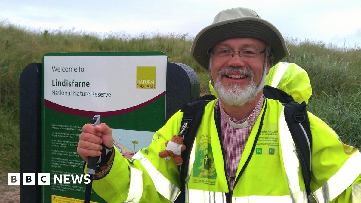 Surrey vicar completes charity walk to Holy Island - BBC News
