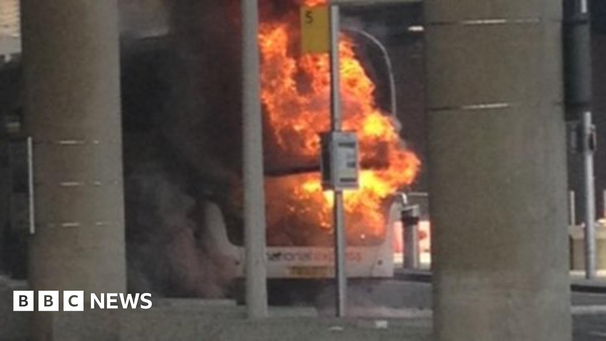 Coach catches fire at Gatwick Airport - BBC News