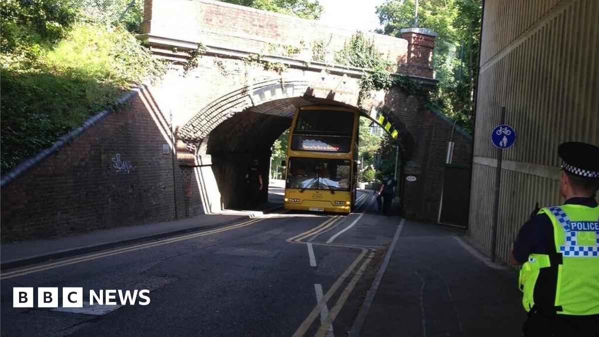 Westbourne mechanic gets bus wedged under bridge - BBC News