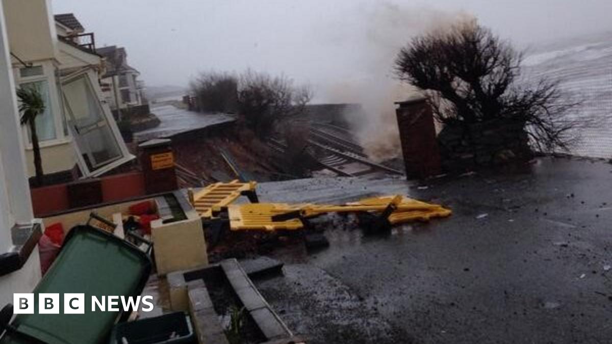 UK storms destroy railway line and leave thousands without power - BBC News