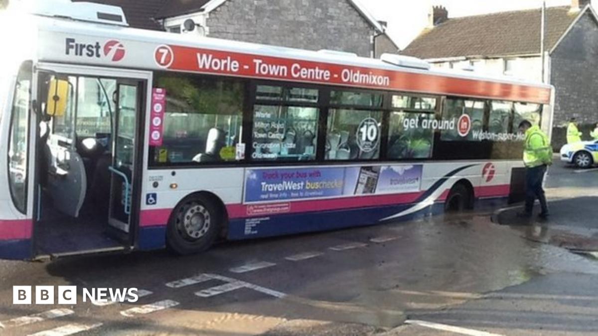 Bus becomes trapped in hole in road in Weston-super-Mare - BBC News