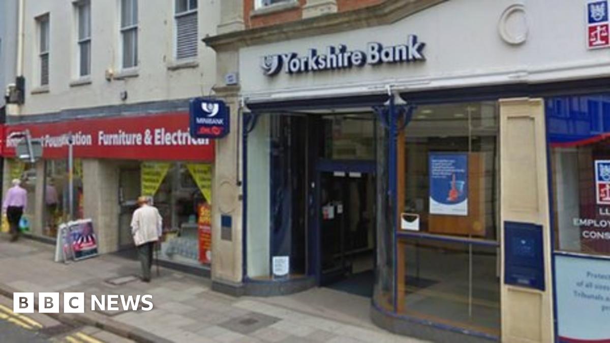 Woman with coat on head robs Grantham bank - BBC News
