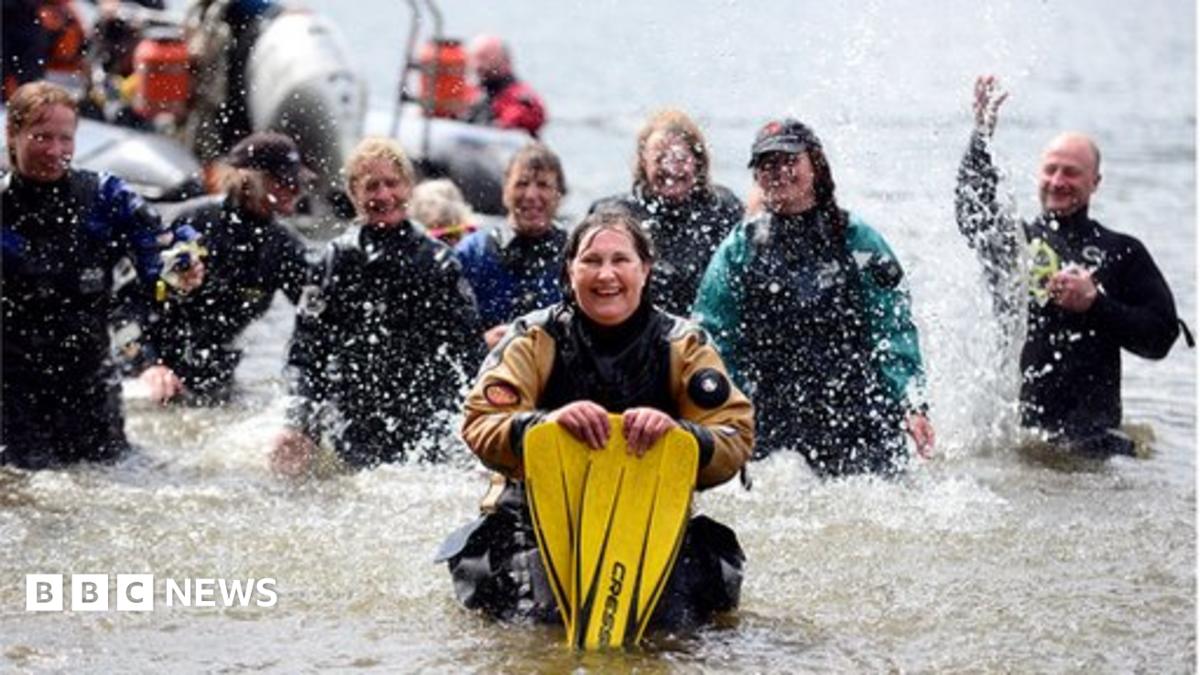 Coniston charity swims in memory of Duncan Priestly - BBC News
