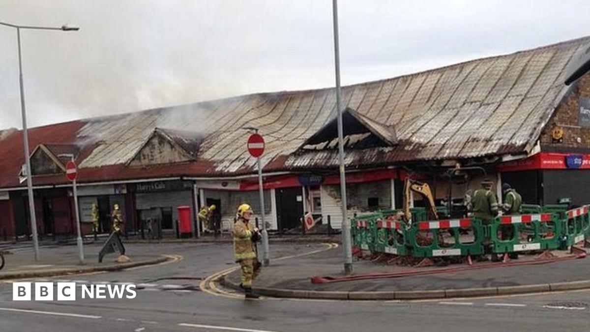 Huyton blaze: Fire spreads through parade of shops - BBC News