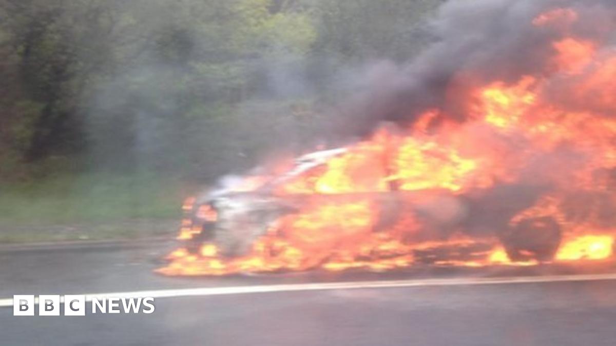 Three escape as car catches fire on M8 - BBC News