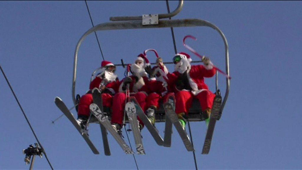 Charity event sees skiers dressed as Santa Claus on slopes - BBC Newsround