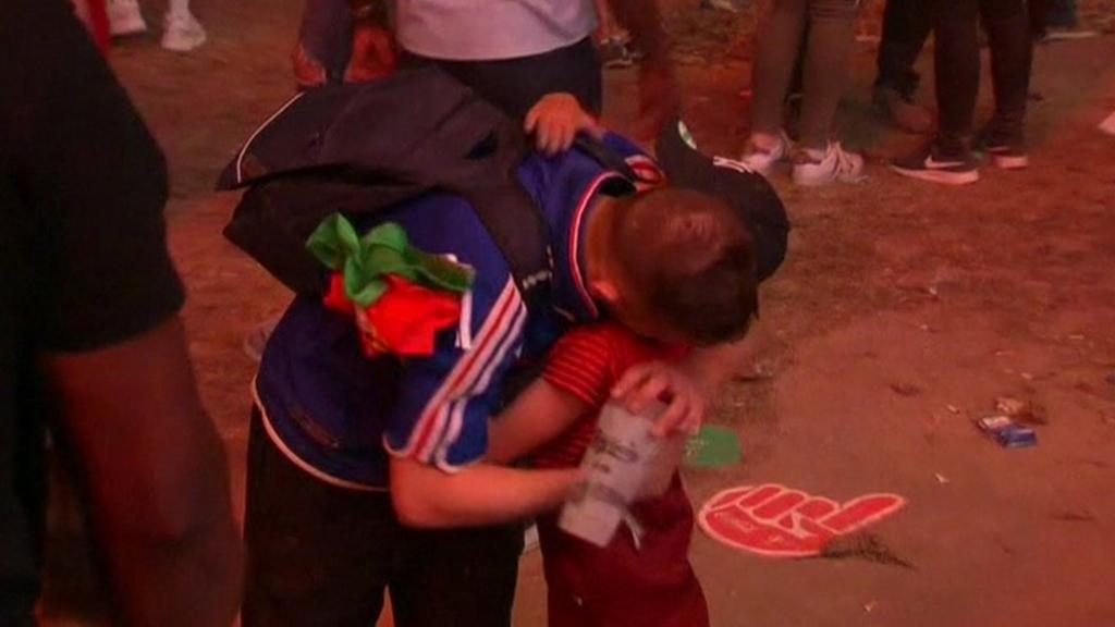 Portuguese boy hugs crying French fan - BBC Newsround