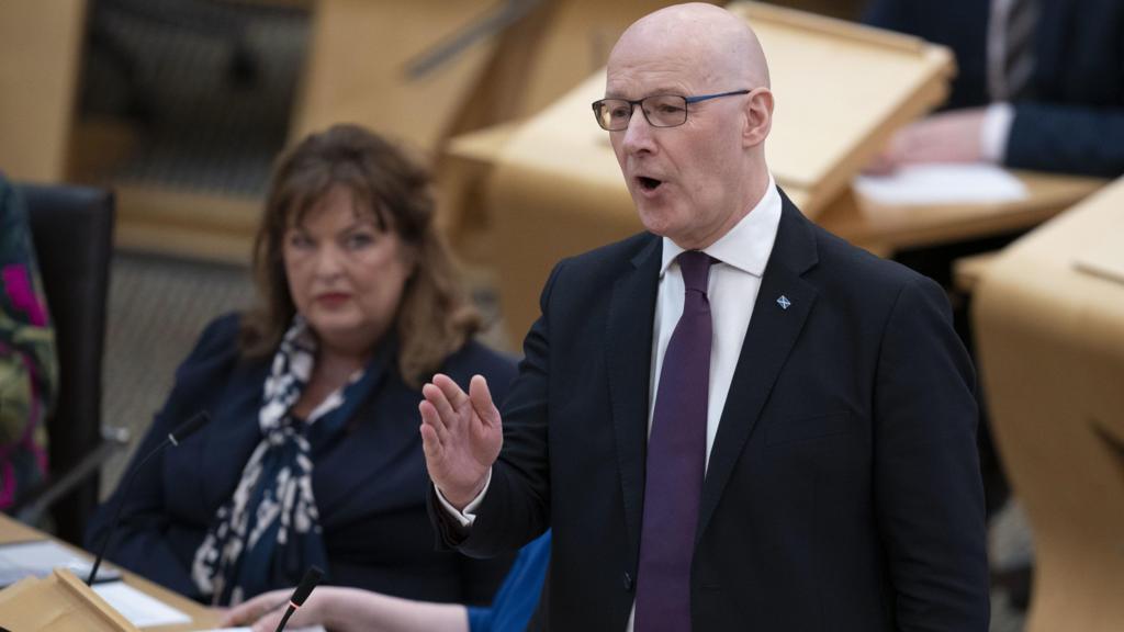 Swinney accused of 'miserly' tax cuts in the budget at FMQs - BBC News