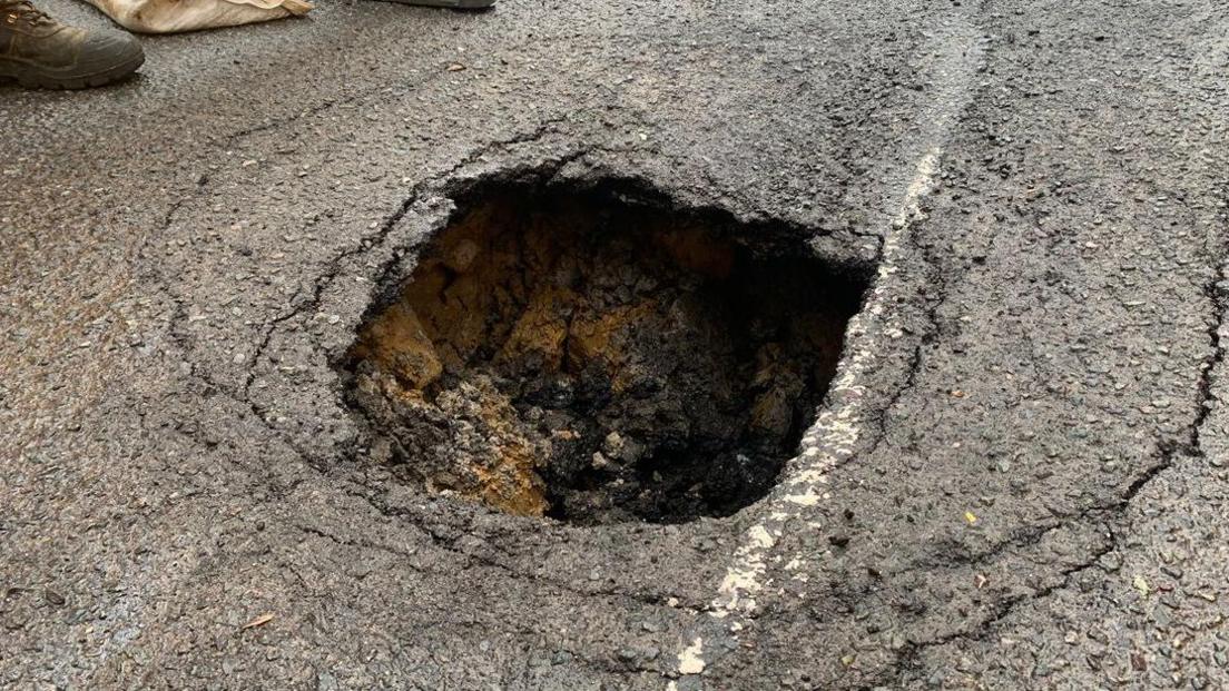 Sinkhole opens up on Sheffield street due to heavy rainfall - BBC News