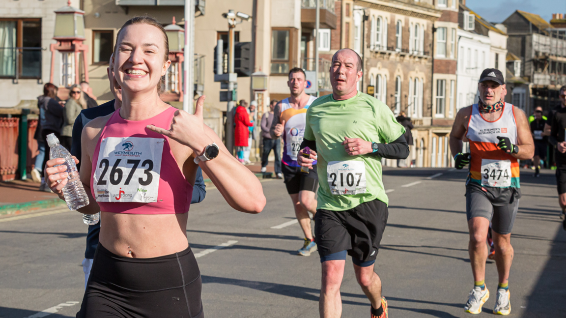 Runners descend on Weymouth for seaside half marathon - BBC News