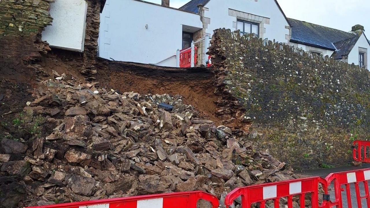 Warning after Dittisham wall collapses outside hall - BBC News